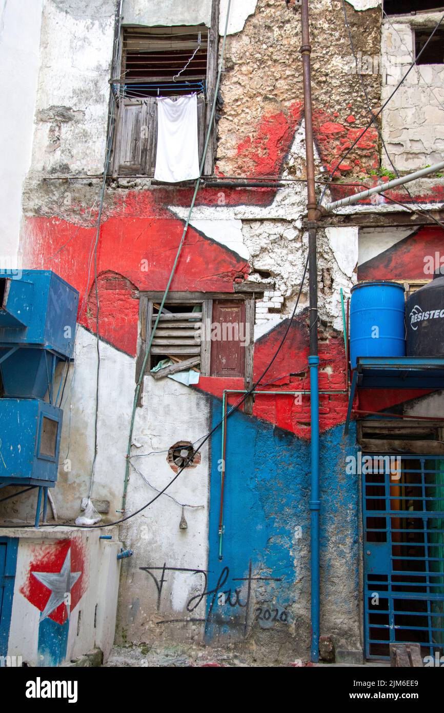 The back of an ally in Havana, Cuba decorated in the colors of the ...
