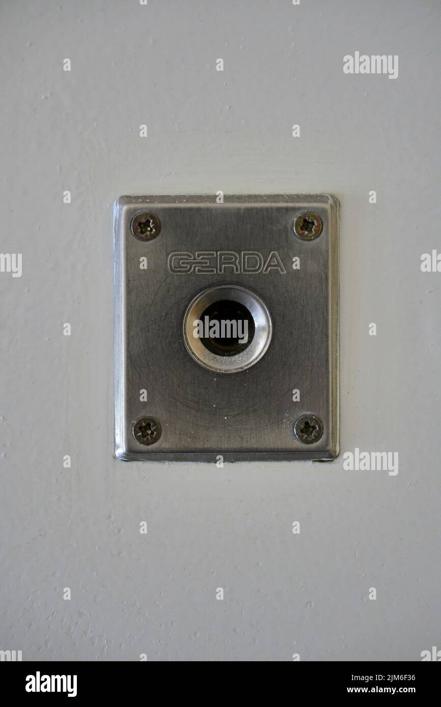 A vertical shot of a Gerda brand security lock on an entrance door ...