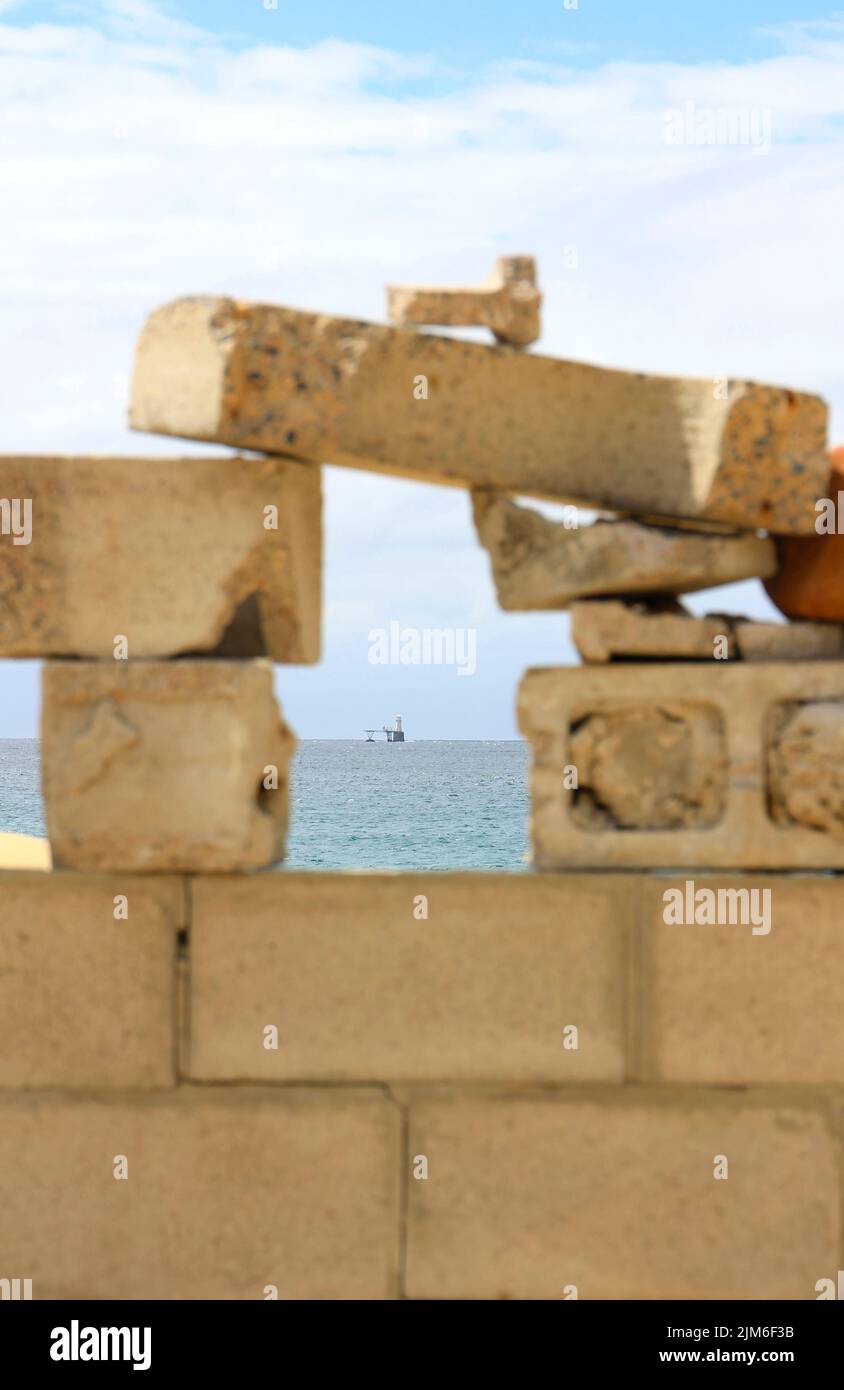Silhouette of Roman Rock Lighthouse, framed by cement brickwork Stock ...