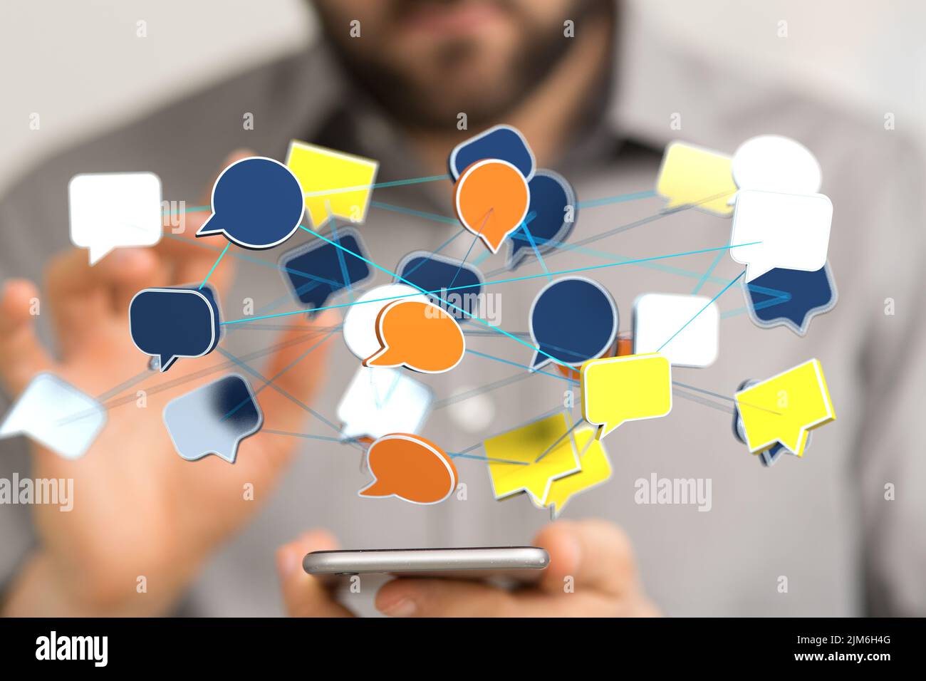 A blurred man holding a smartphone and clicking on speech bubbles signs ...