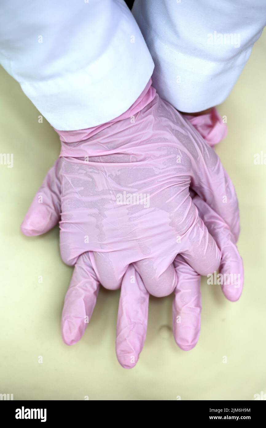 The student's hands are seen performing chest compressions during ...