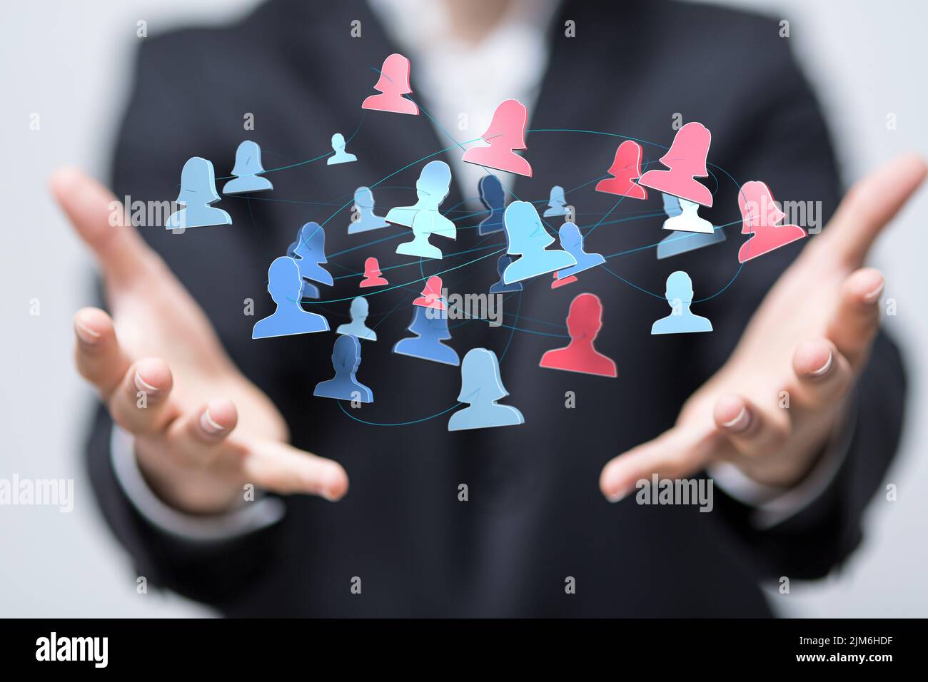 A businessman holding a floating digital render of profile icons-networking concept Stock Photo ...