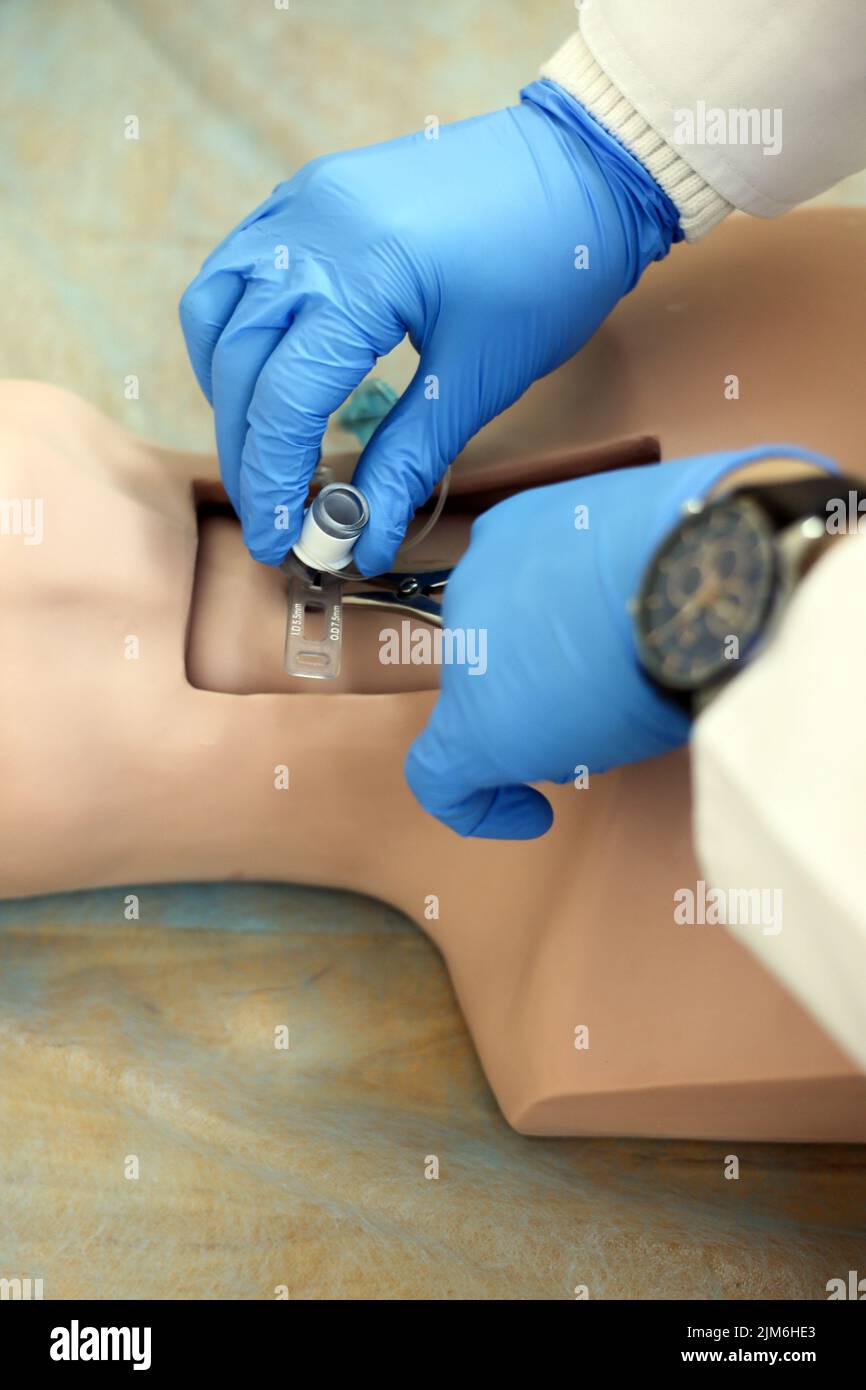 A student learning how to perform Cricothyrotomy. HAL patient manikin ...
