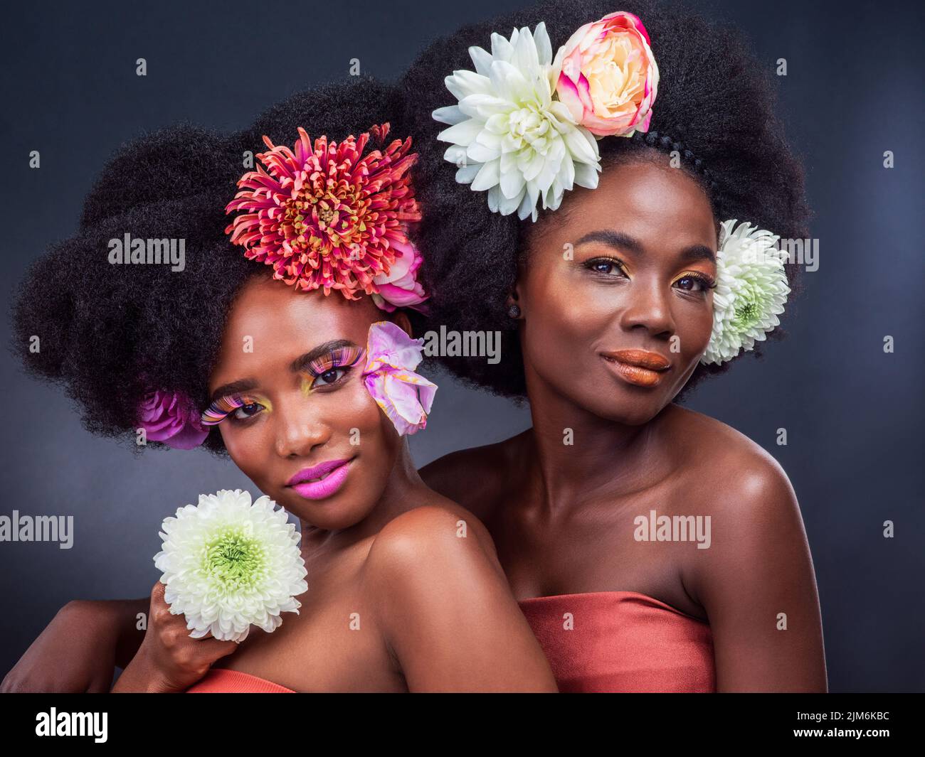 We have nature to thank. two beautiful women posing together with flowers in their hair Stock ...