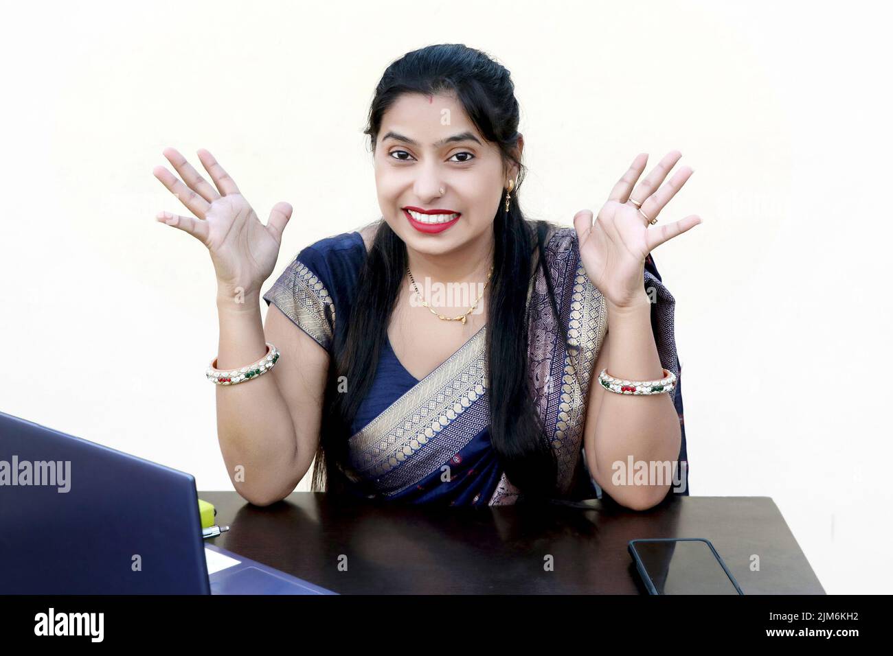 Portrait of surprised Indian young woman against white background Stock ...