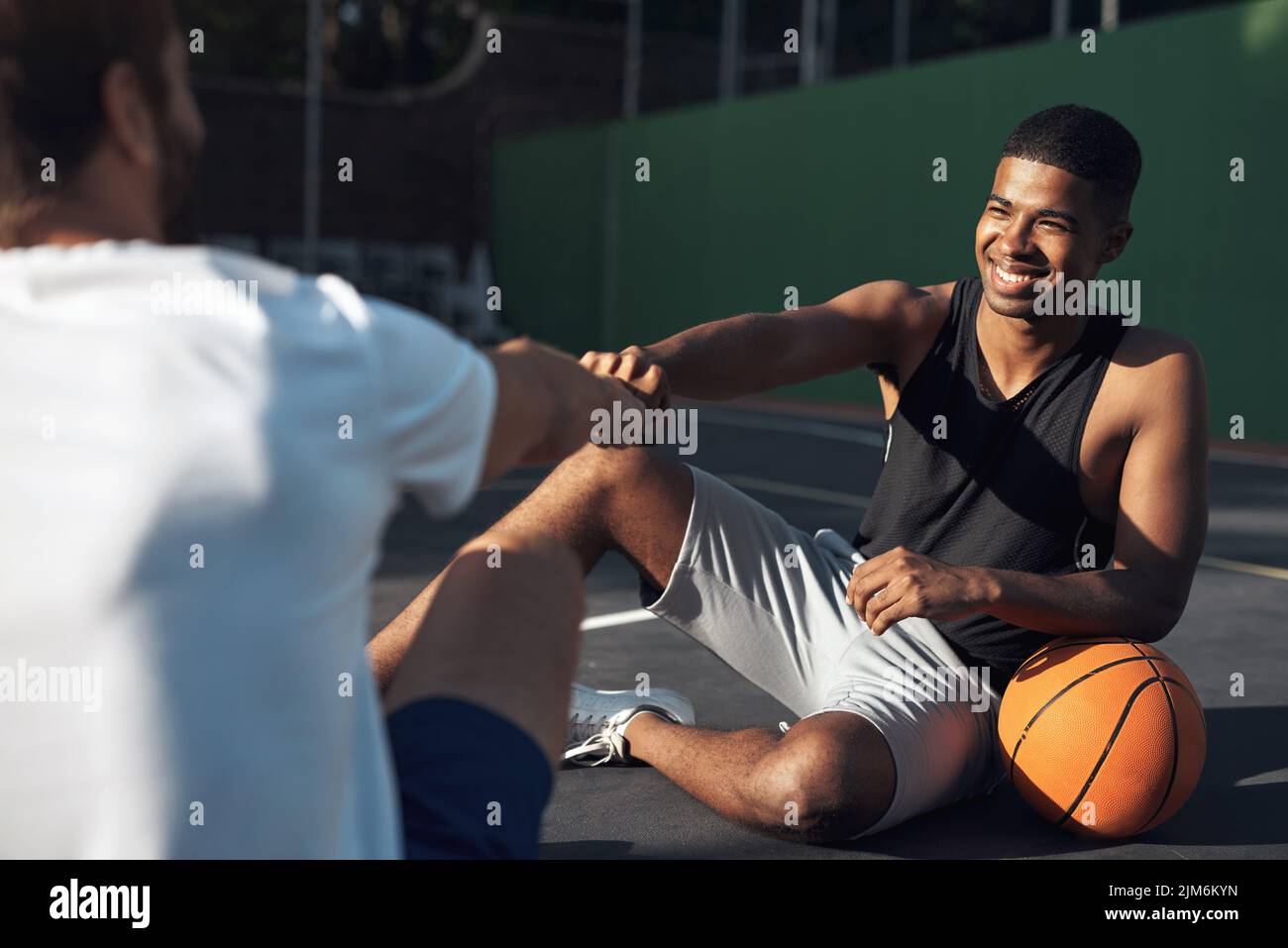 Boom goes the dynamite. a sporty young man giving his teammate a fist ...