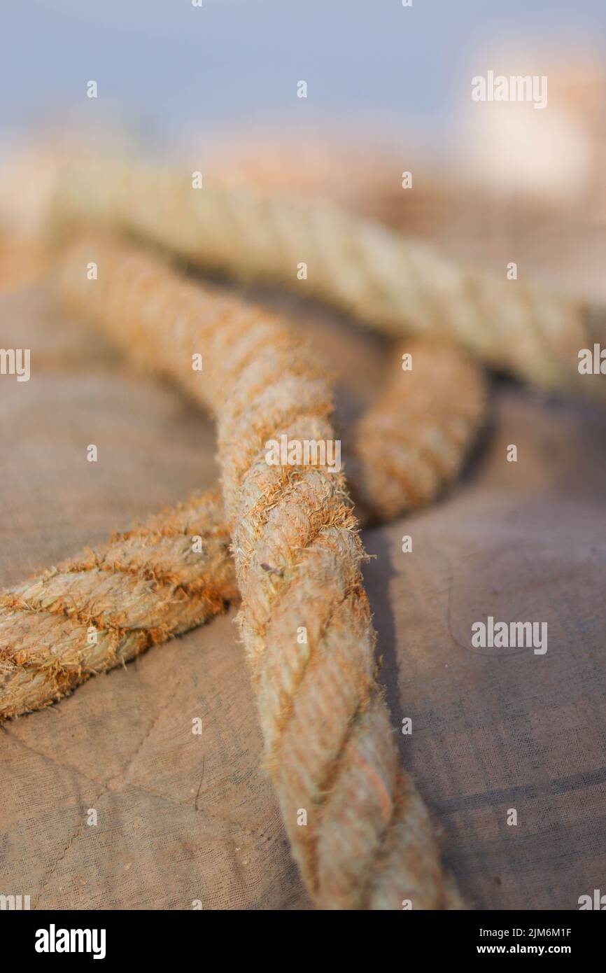 A vertical shot of a rope on a brown cloth Stock Photo - Alamy