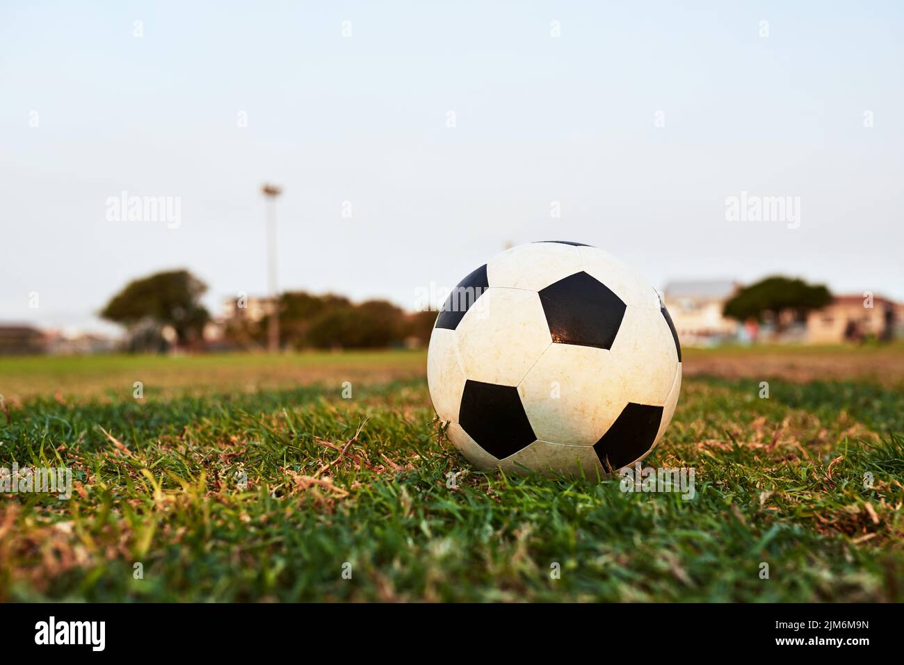Ready for kickoff. Closeup shot of a soccer ball on an empty sports ...