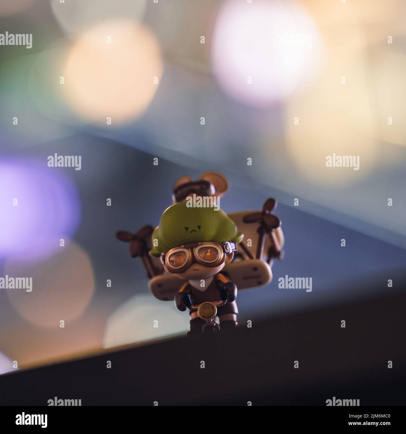 A closeup of a Pop Mart toy figurine of Dimoo preparing to fly isolated ...