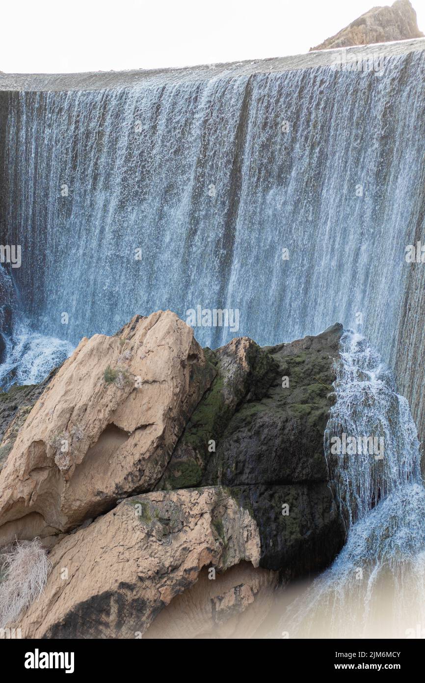 A vertical shot of a waterfall splashing the rocks Stock Photo - Alamy