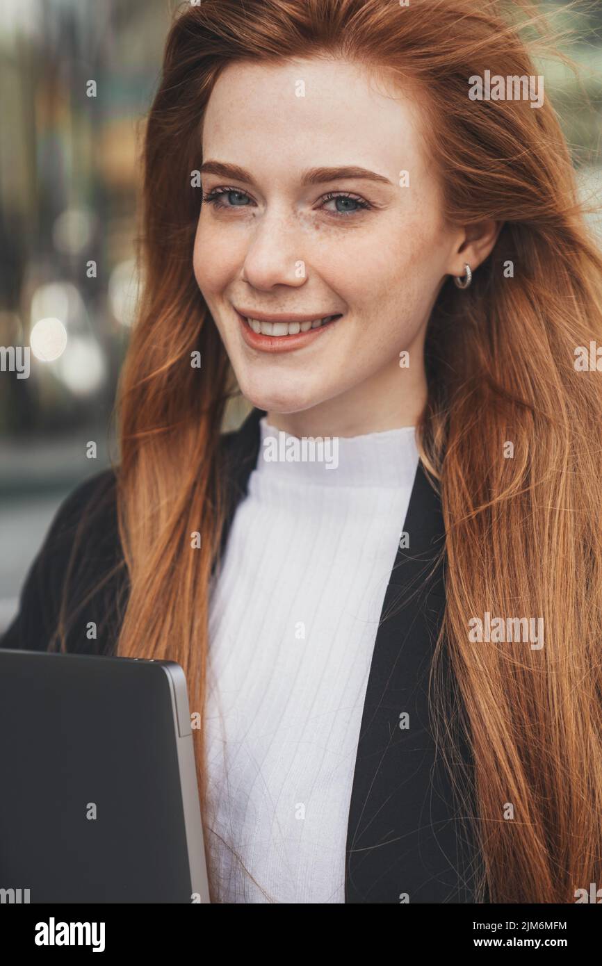 Close-up portrait lady with long ginger hair with smile, looking ...