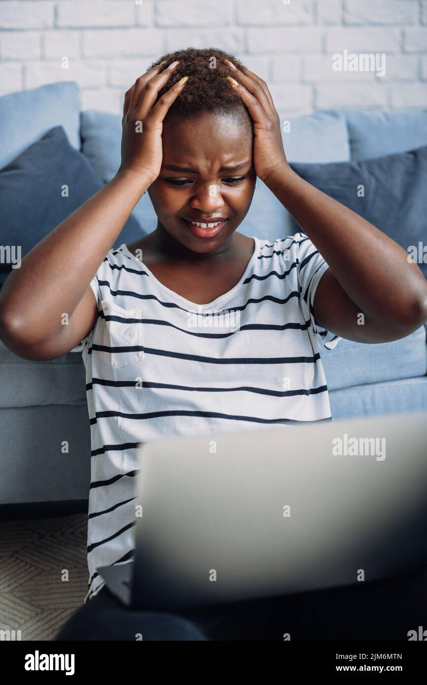 Afro Woman Holding Head In Hands Upset Worried About Online Problem