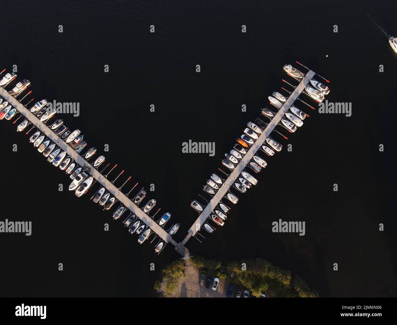 The aerial view of the harbor with many boats on the water surface near ...