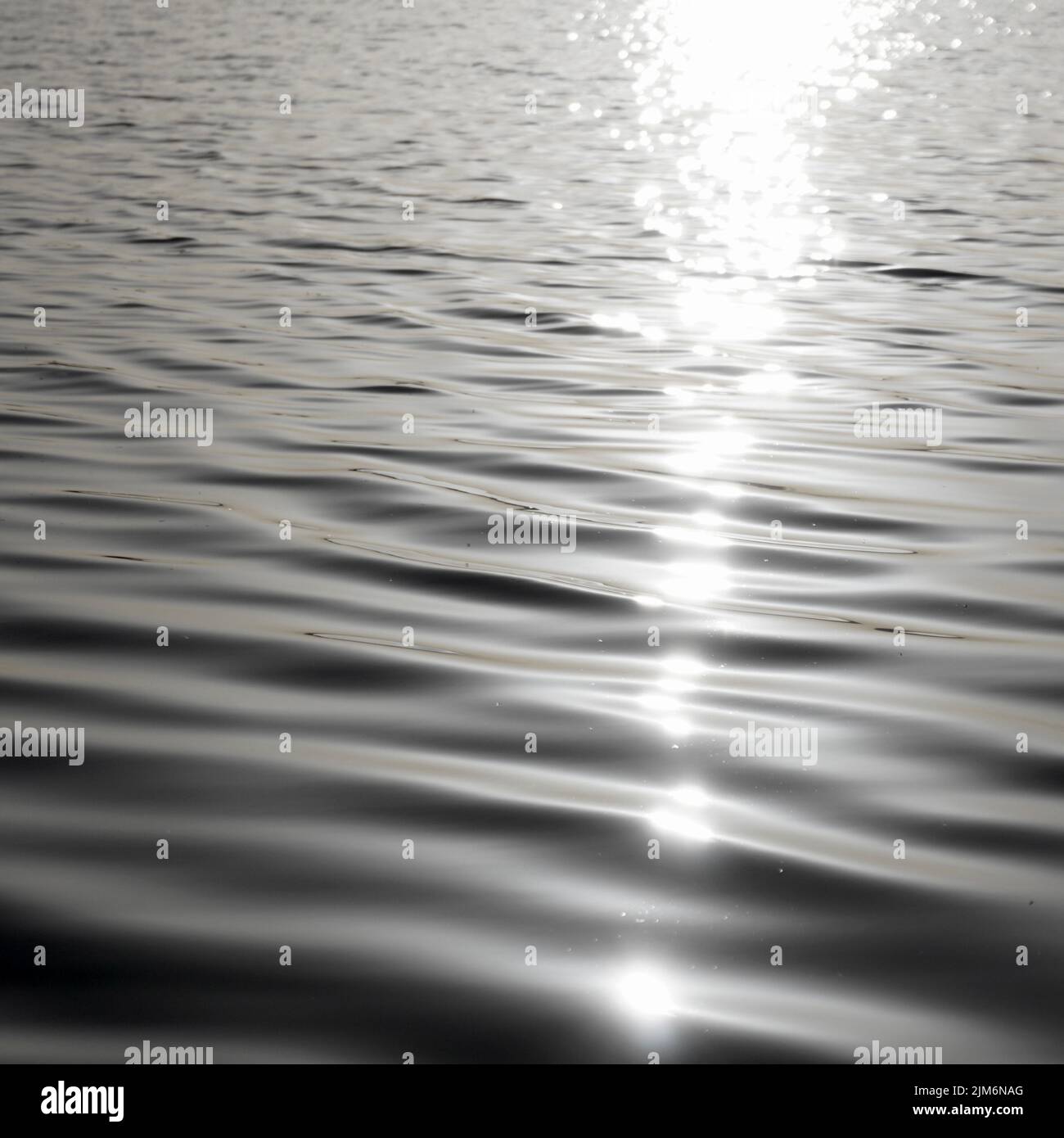 A water surface with falling sun rays Stock Photo - Alamy