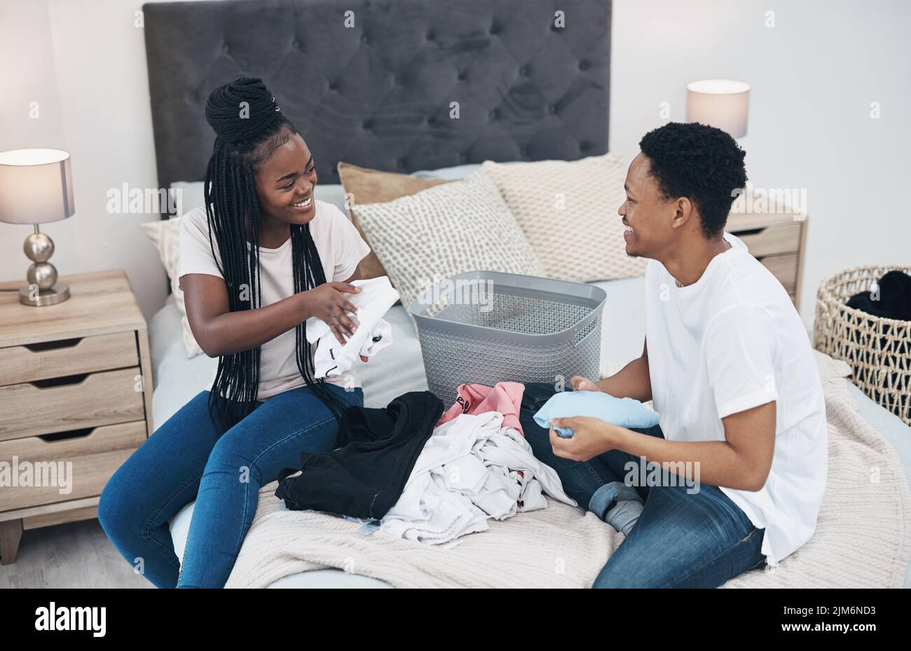 Winning in lockdown takes doing the laundry together. a young couple ...
