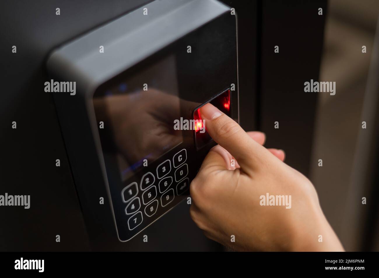 A woman opens the door with her fingerprint. Modern keyless entry lock ...