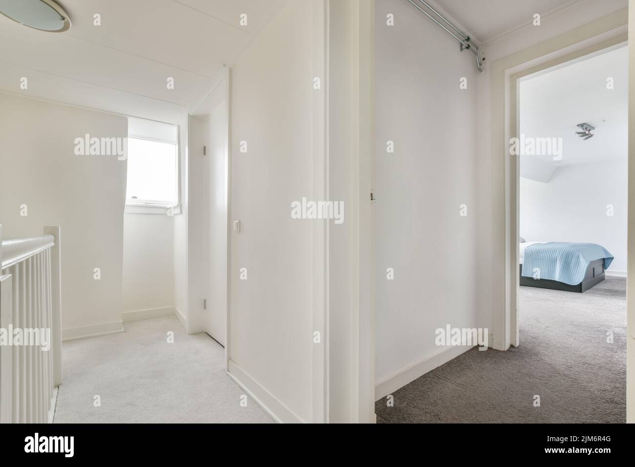 Room with door to balcony and narrow long corridor in perspective in ...