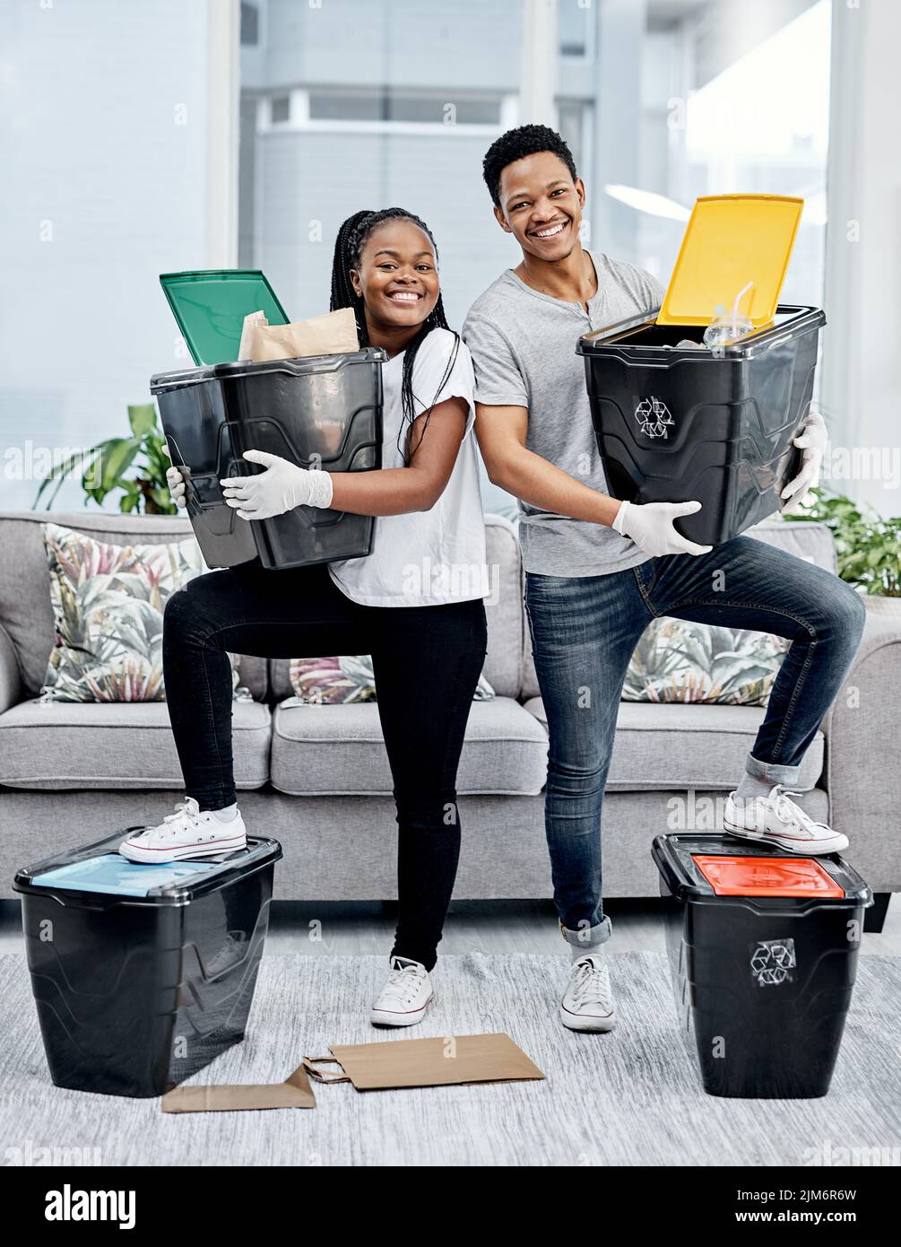 Dont waste it, save it. a young couple recycling their trash at home ...