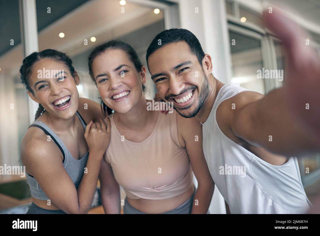 Gym selfies with friends. Cropped portrait of three young athletes ...
