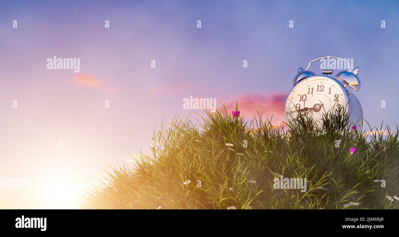 Alarm clock on small hill and grass meadow, environmental with time ...