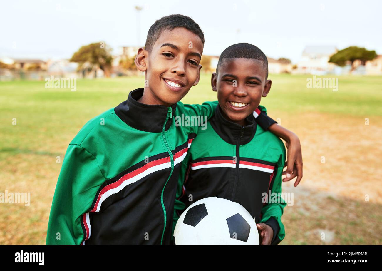 Growing up to become football sensations. Portrait of two young boys ...