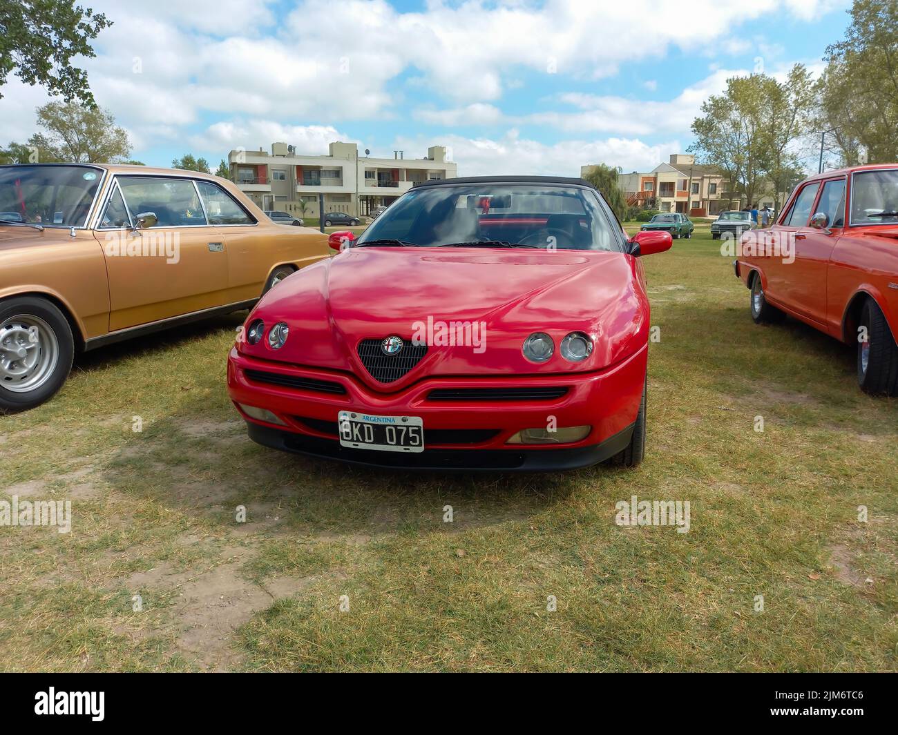 Red sport Alfa Romeo Spider Type 916 roadster early 1990s parked on the ...