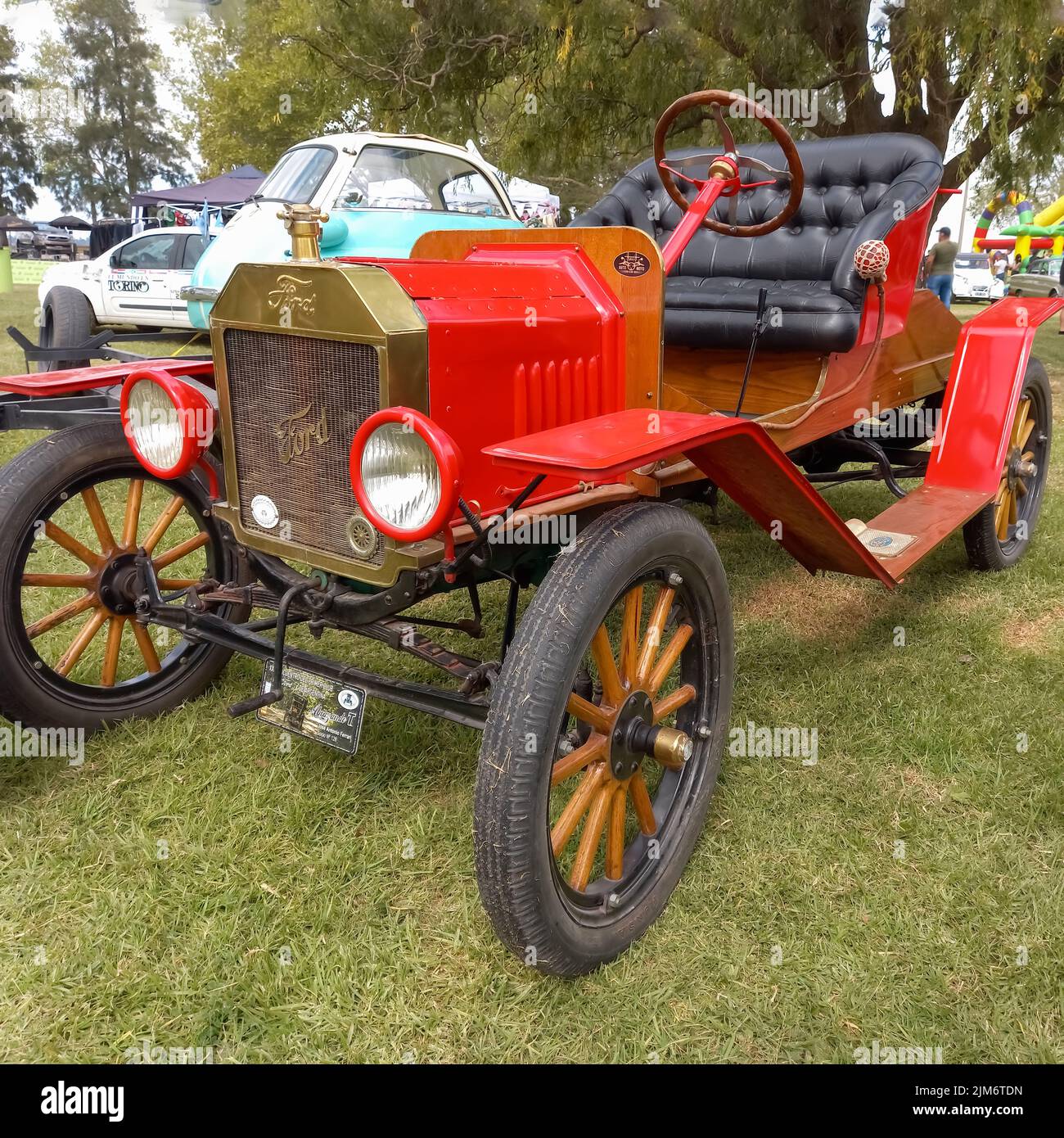 Old red Ford Model T roadster Tudor circa 1920. Side view. Nature green ...