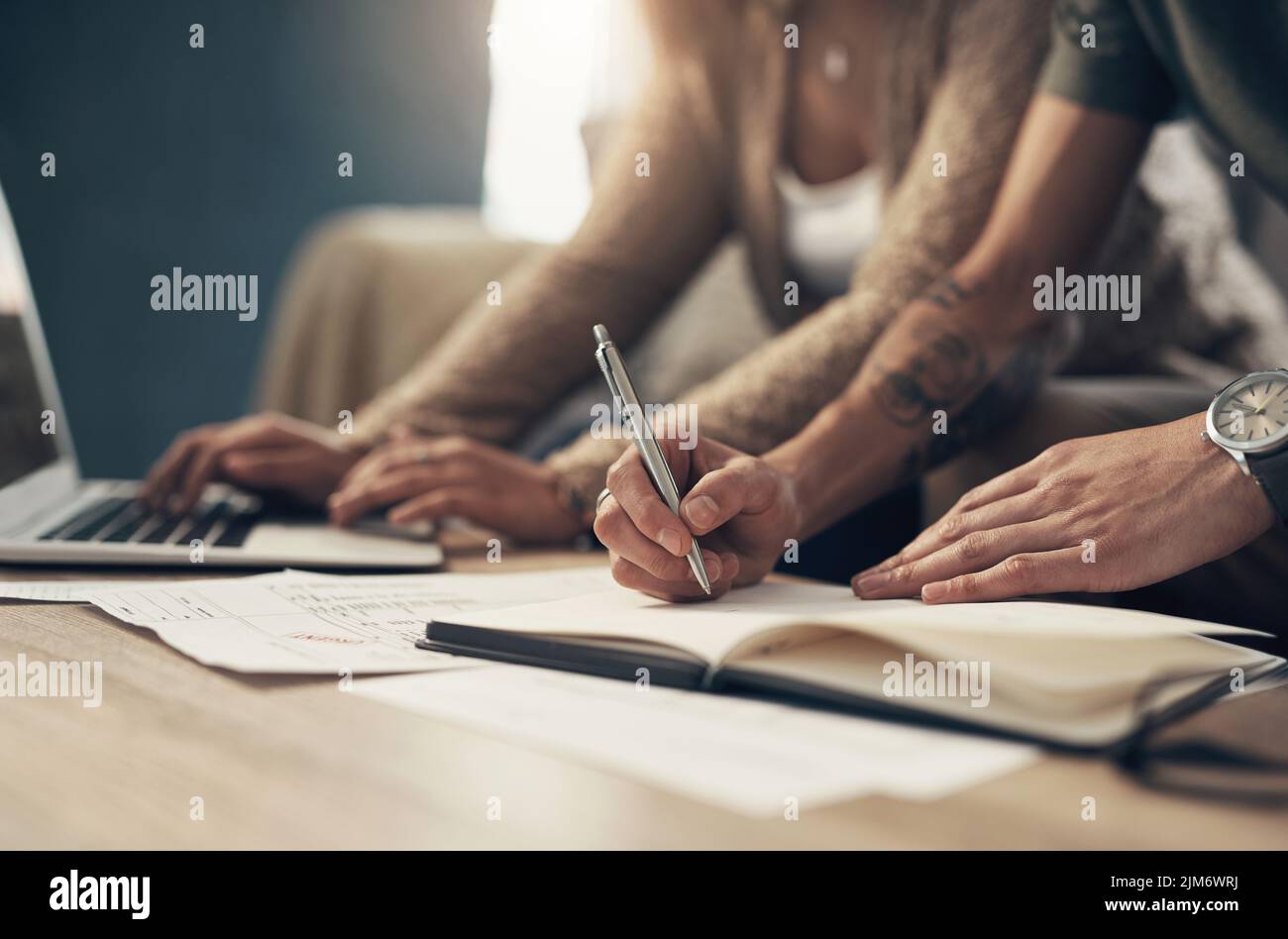 Debt repayment done right. a couple going over paperwork at home Stock ...