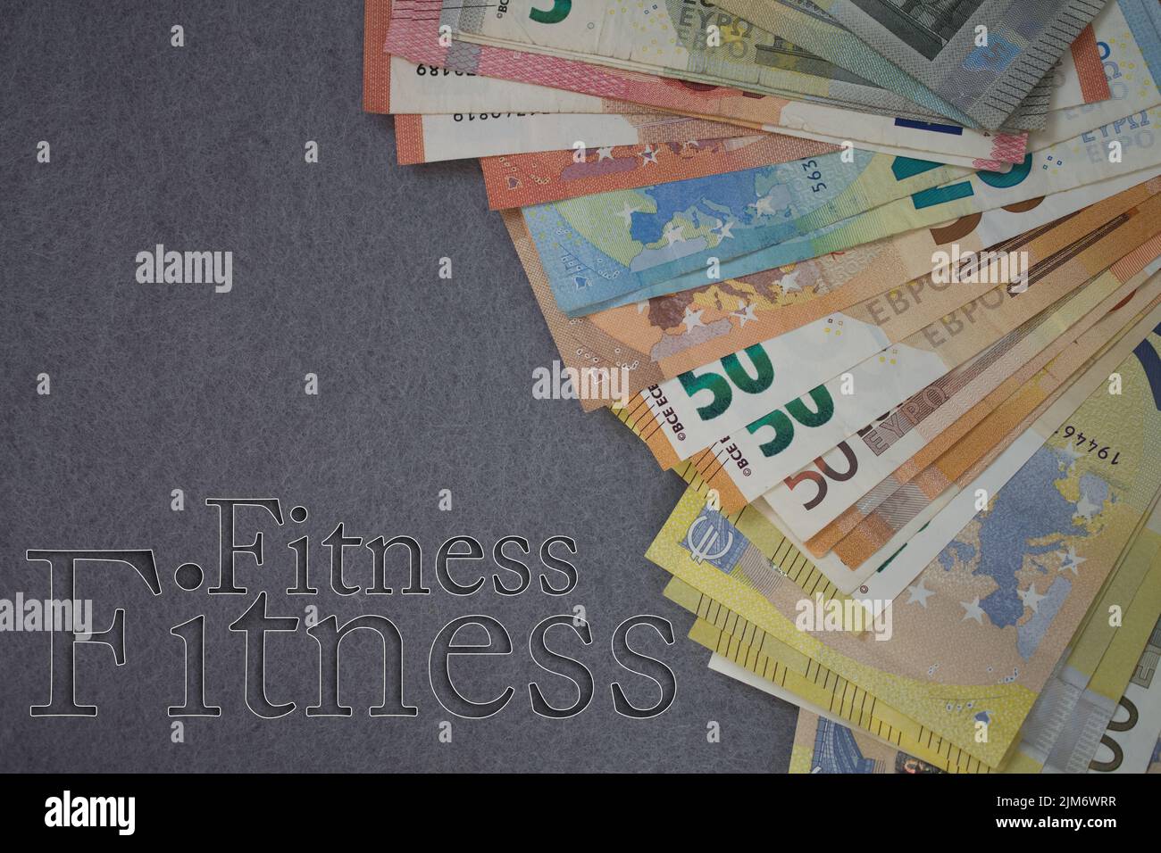 Fitness word with money. Paper currency background with different ...