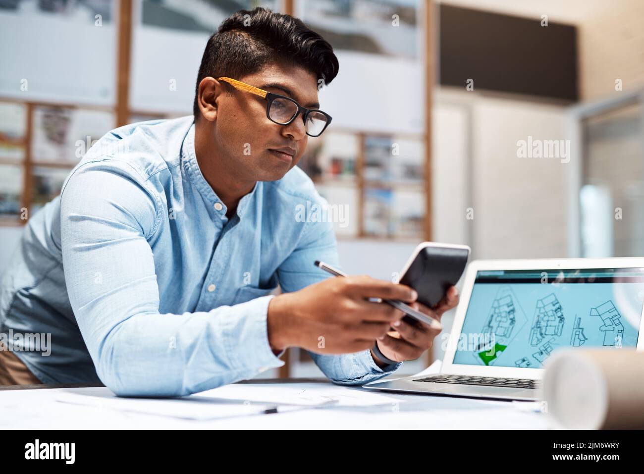 Profiting from his passion for design. a young architect using a ...