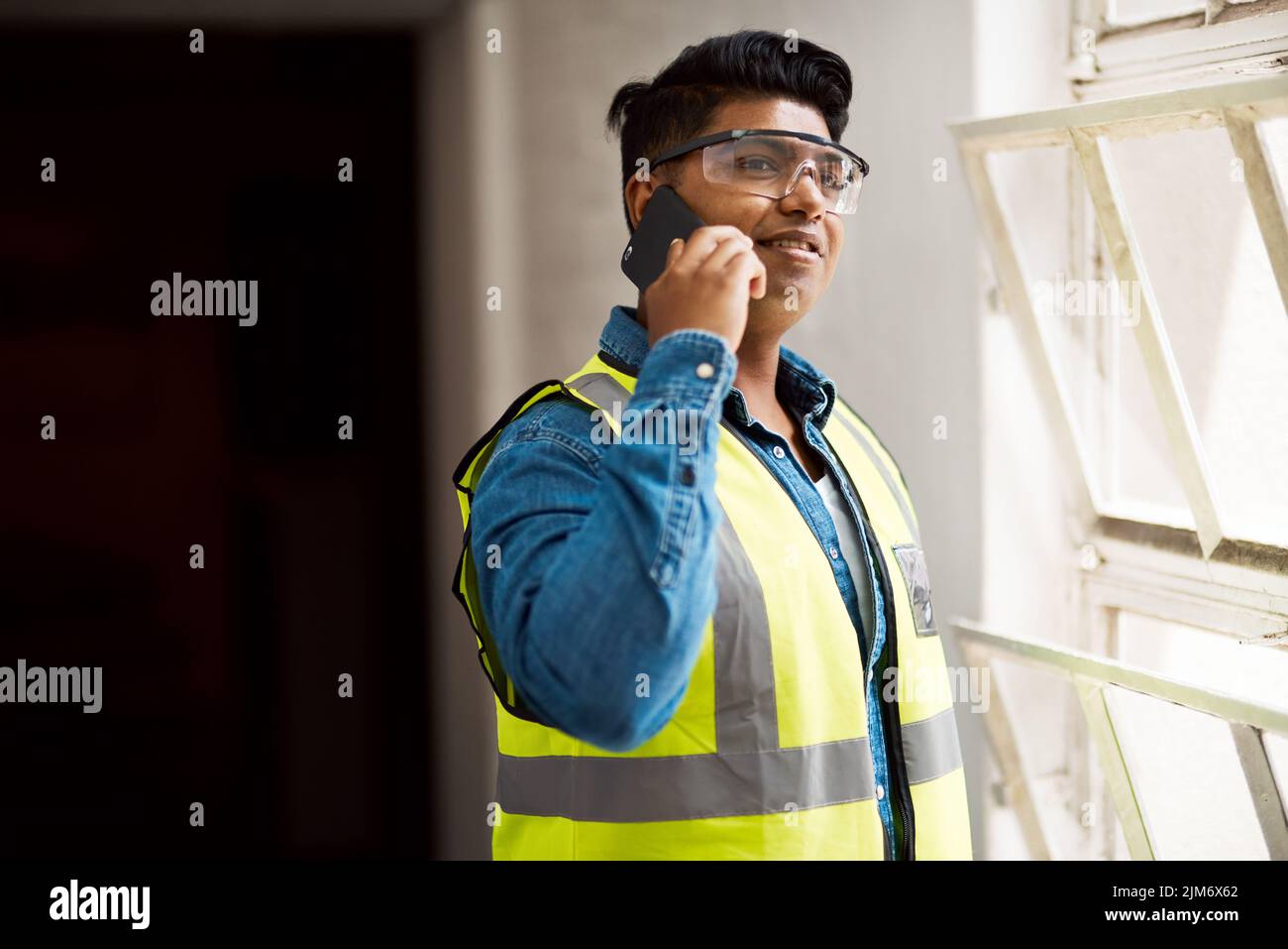 I need your help on this project. a engineer talking on his cellphone ...