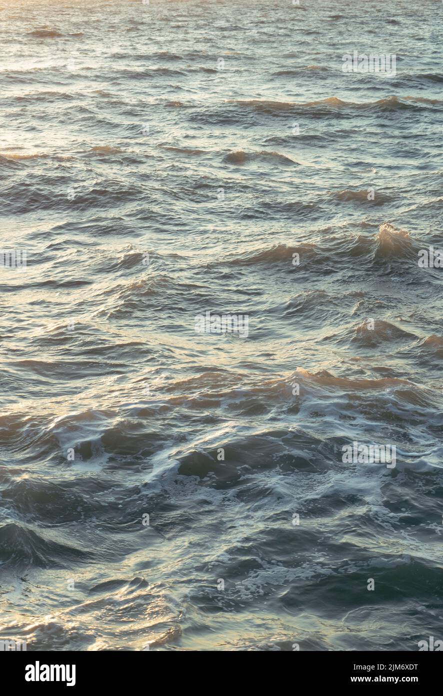 A vertical top view of the choppy sea with sun reflection Stock Photo ...