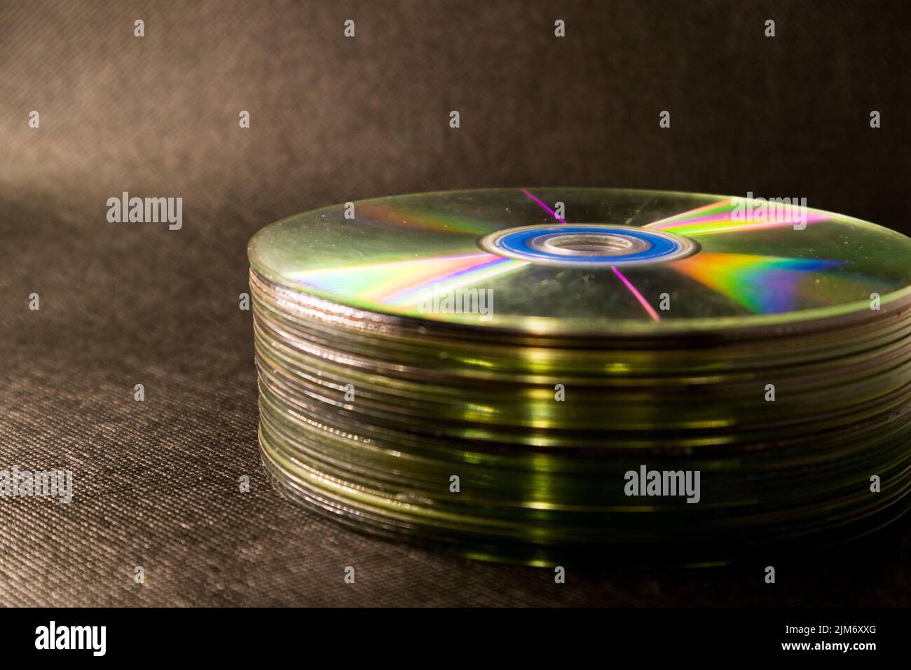 Some Compact Disk, DVDs stacked in a black surface Stock Photo - Alamy