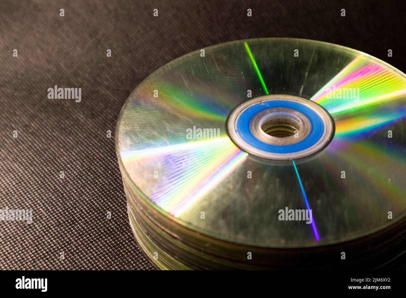 Some old Compact Disk, DVDs stacked in a black surface Stock Photo - Alamy