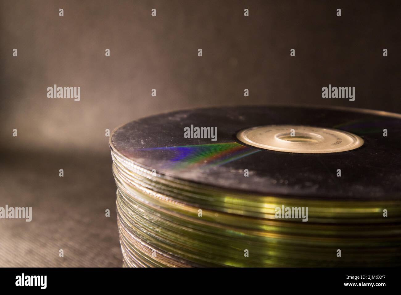 Some old Compact Disk, DVDs stacked in a black surface Stock Photo - Alamy