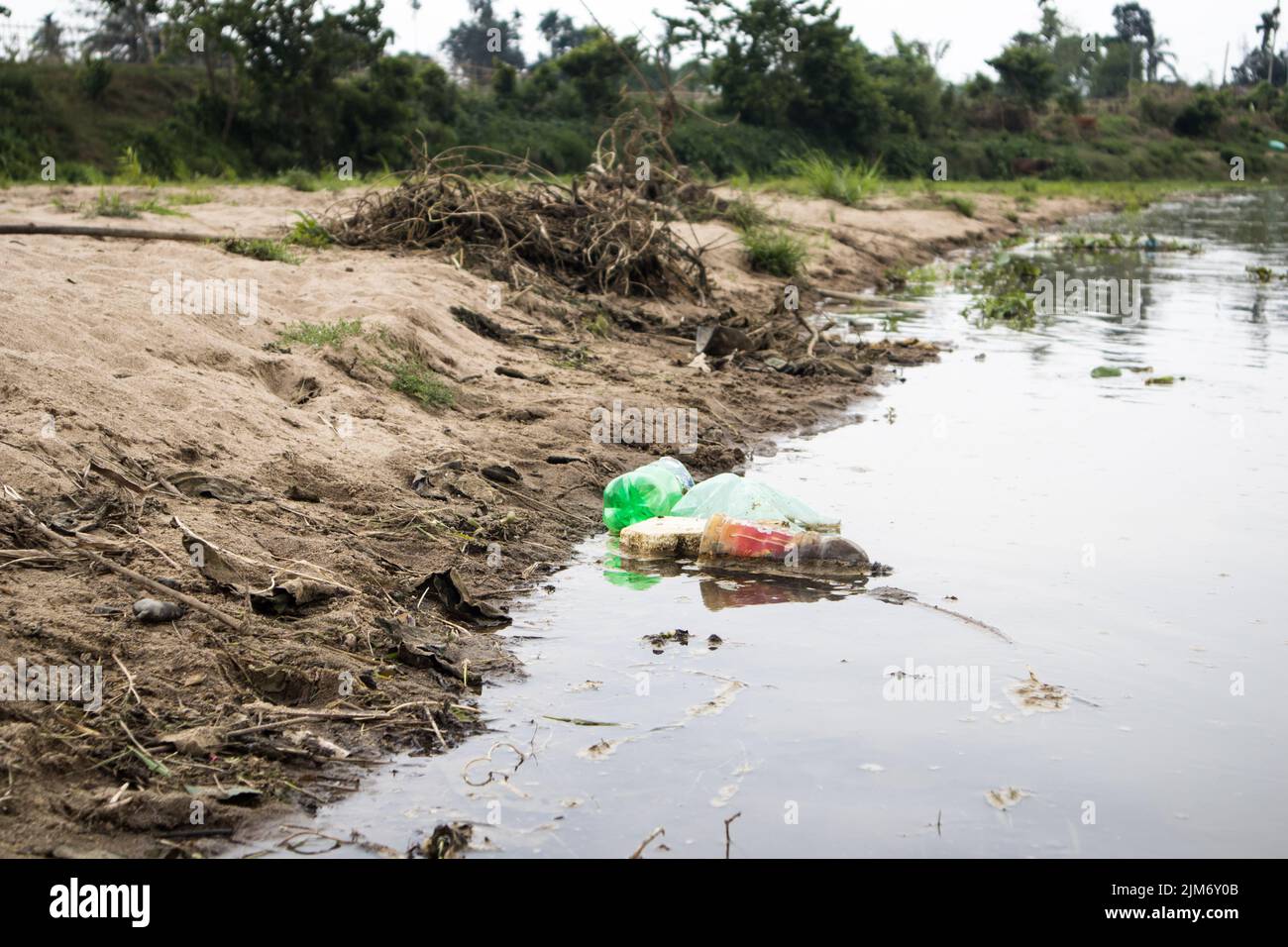 Junk items thrown in the water of the river is polluting the river ...