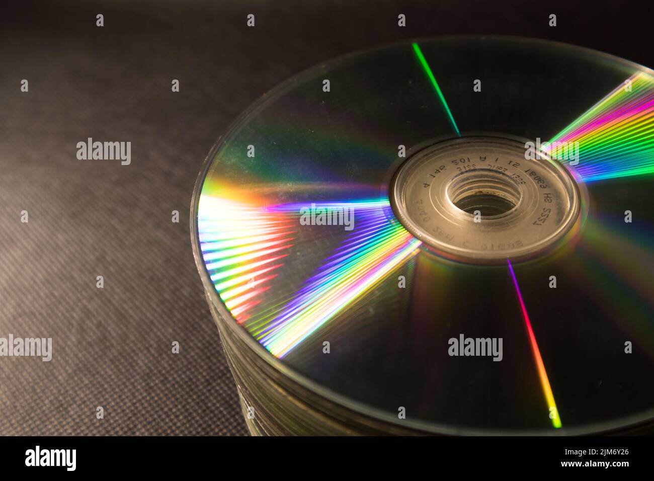 Some old Compact Disk, DVDs stacked in a black surface Stock Photo - Alamy