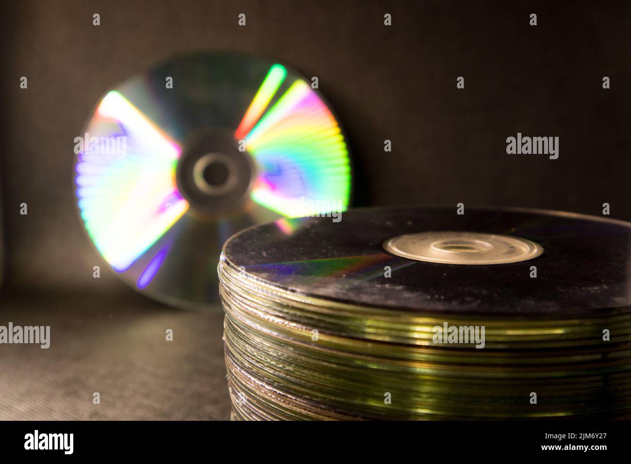 Some old Compact Disk, DVDs stacked in a black surface Stock Photo - Alamy