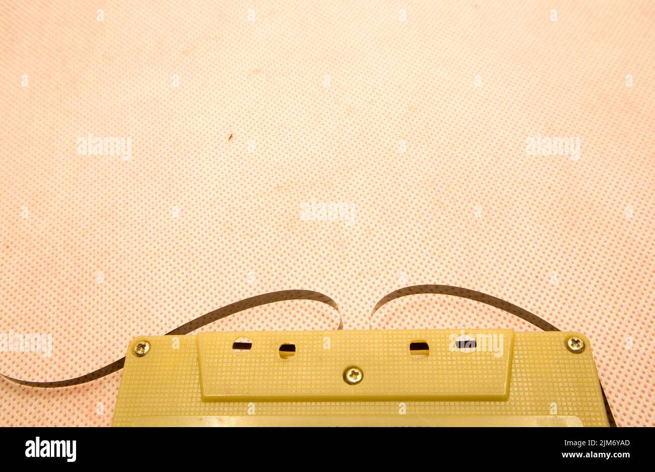 A torn magnetic tape of an audio cassette. Tape is taken out from its ...