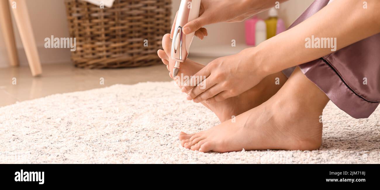 Young woman doing pedicure at home Stock Photo - Alamy