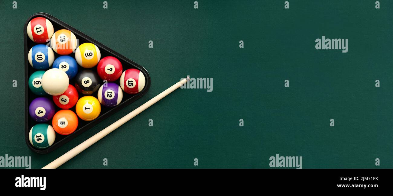 Billiard balls in triangle and cue on table, top view. Banner for ...