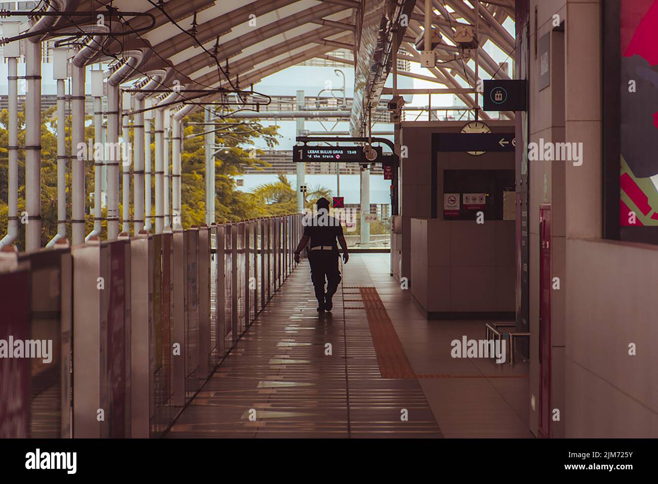 An officer walking trough by the subway station Stock Photo - Alamy