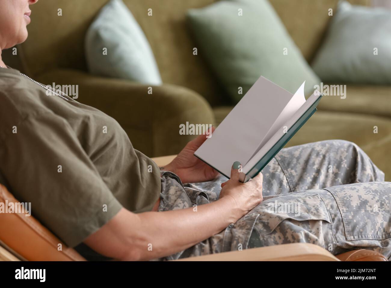 Mature female soldier reading book at home, closeup Stock Photo - Alamy
