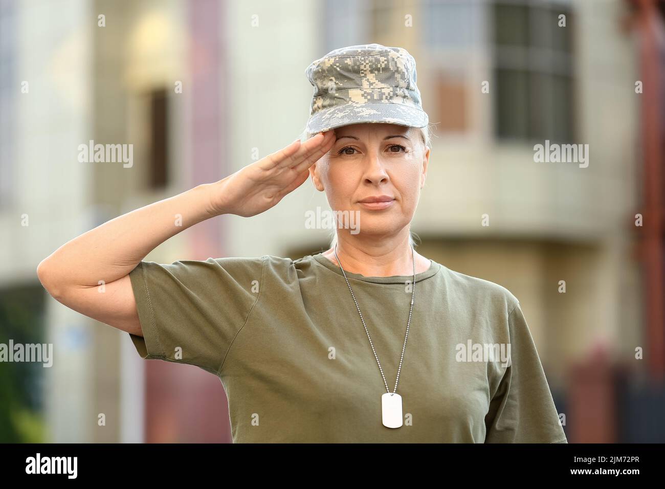 Mature female soldier saluting outdoors Stock Photo - Alamy
