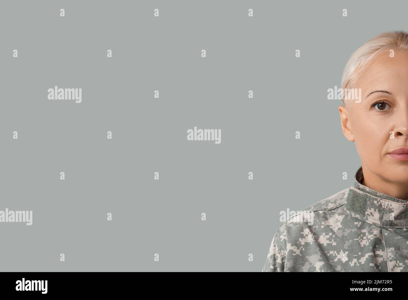 Mature female soldier on grey background Stock Photo - Alamy