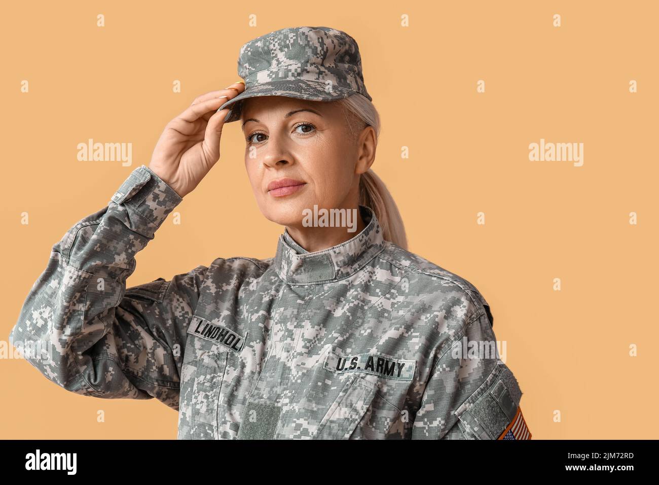 Mature female soldier on beige background Stock Photo - Alamy