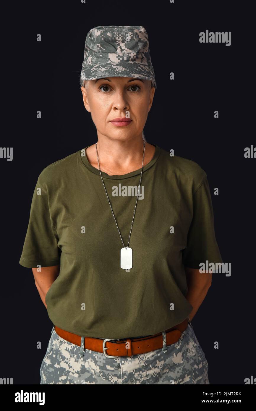 Mature female soldier on black background Stock Photo - Alamy