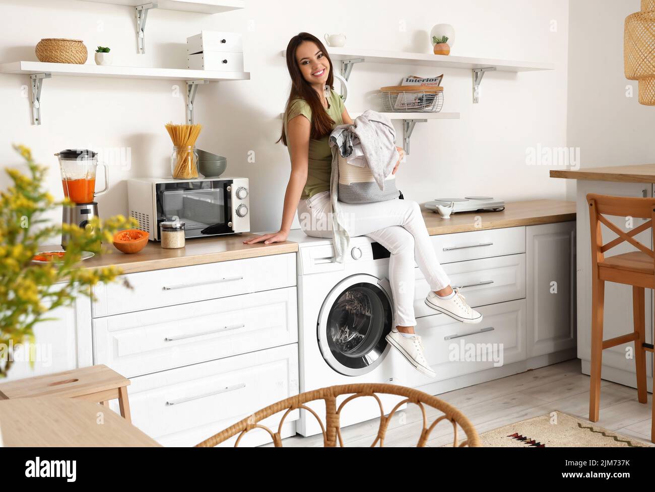 Woman sitting on washing machine hi-res stock photography and images ...