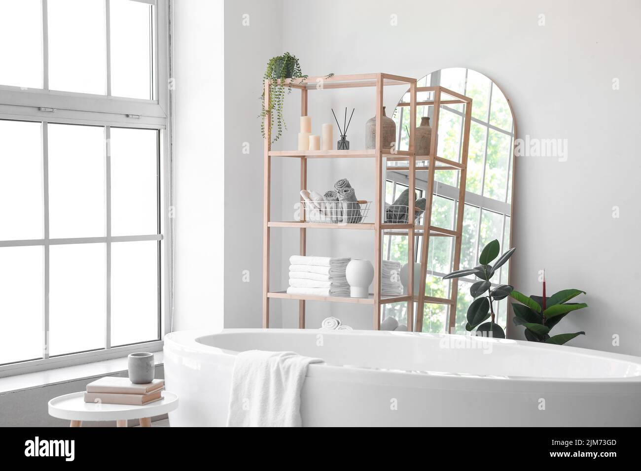 Interior of light bathroom with wooden shelving unit and mirror Stock ...