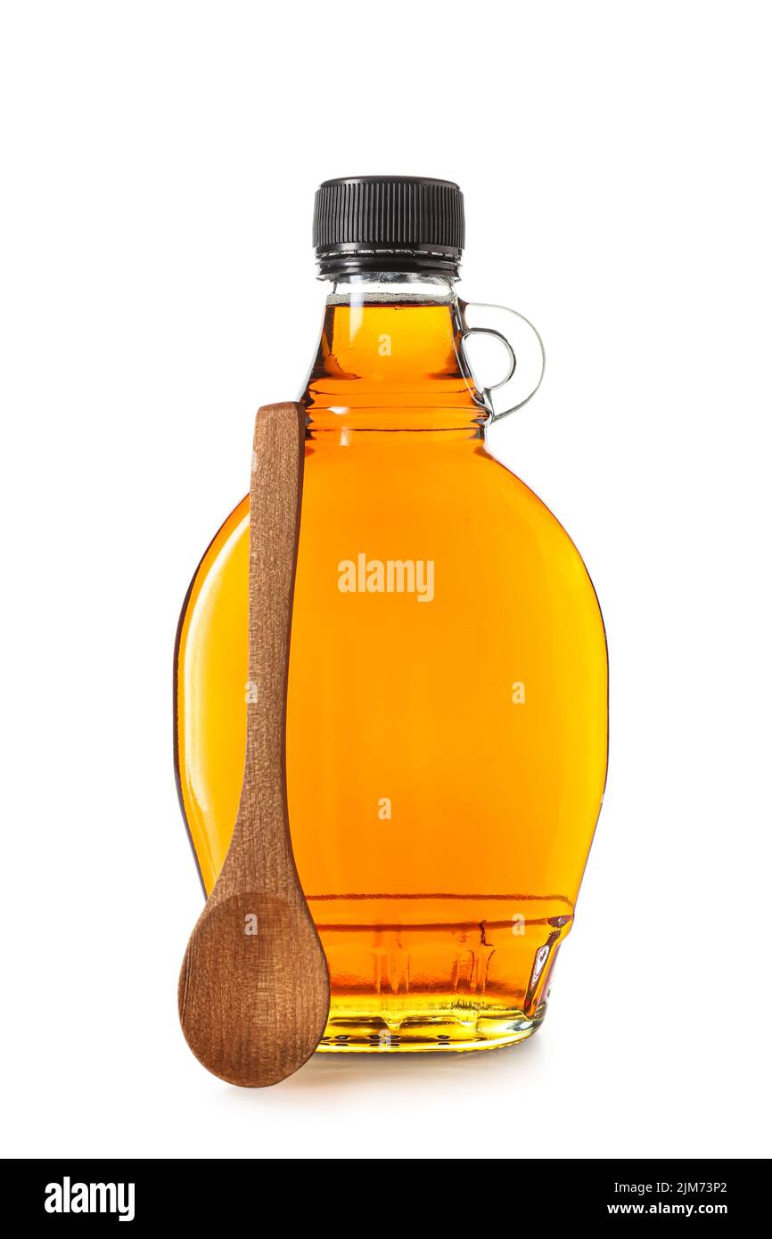 Bottle of maple syrup and wooden spoon on white background Stock Photo ...